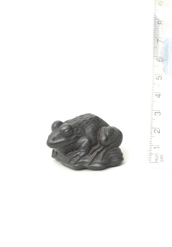 Bonhams : An ebony netsuke of a frog on driftwood Attributed to Seiyodo ...