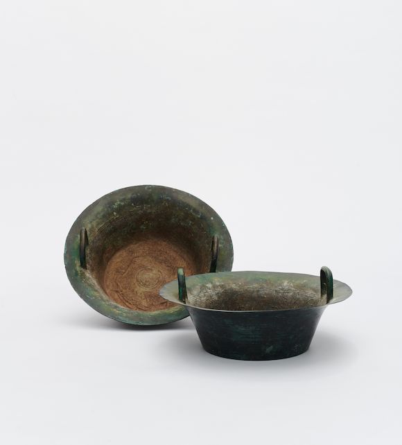 Bonhams : A PAIR OF EASTERN 'ARCHAIC' TWIN HANDLED BRONZE BOWLS