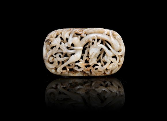 Bonhams : A mottled black and white jade reticulated 'dragon' plaque ...