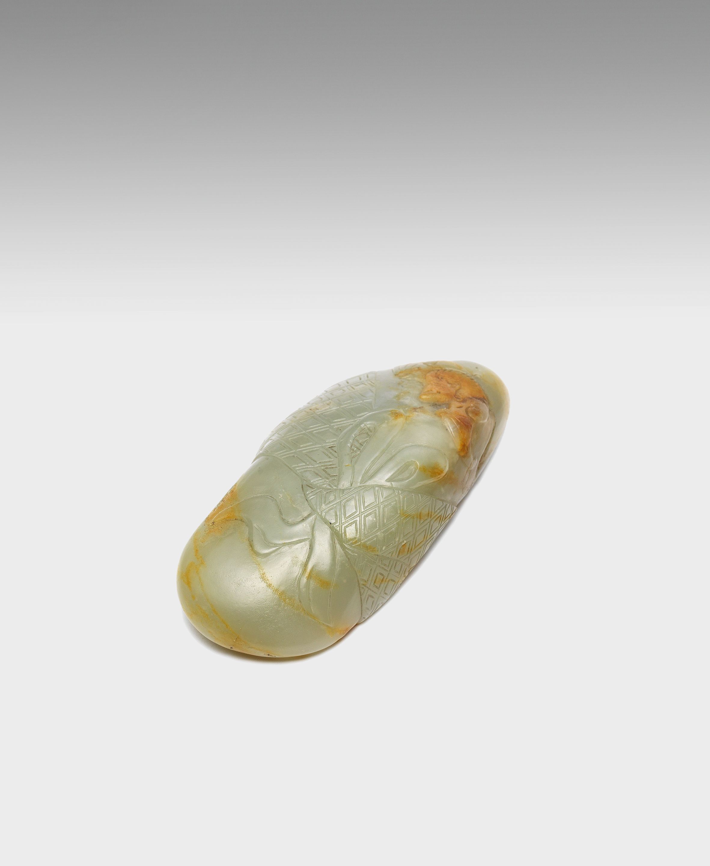 Bonhams : A green and russet jade pebble-form pendant 17th/18th century