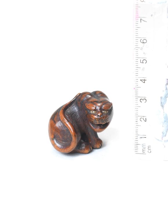 Bonhams : A wood netsuke of a seated tiger By Hakuryu II, 19th century