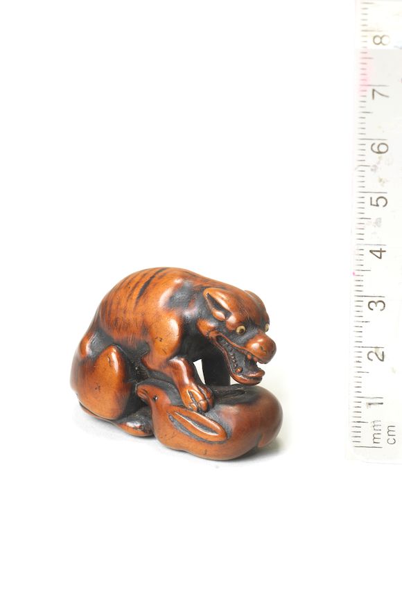 Bonhams : A wood netsuke of a wolf After Okatomo, Kyoto, early 19th century