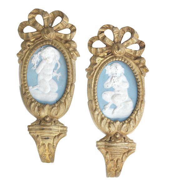 Bonhams : Two 19th century gilt brass porcelain inset curtain tie backs (2)
