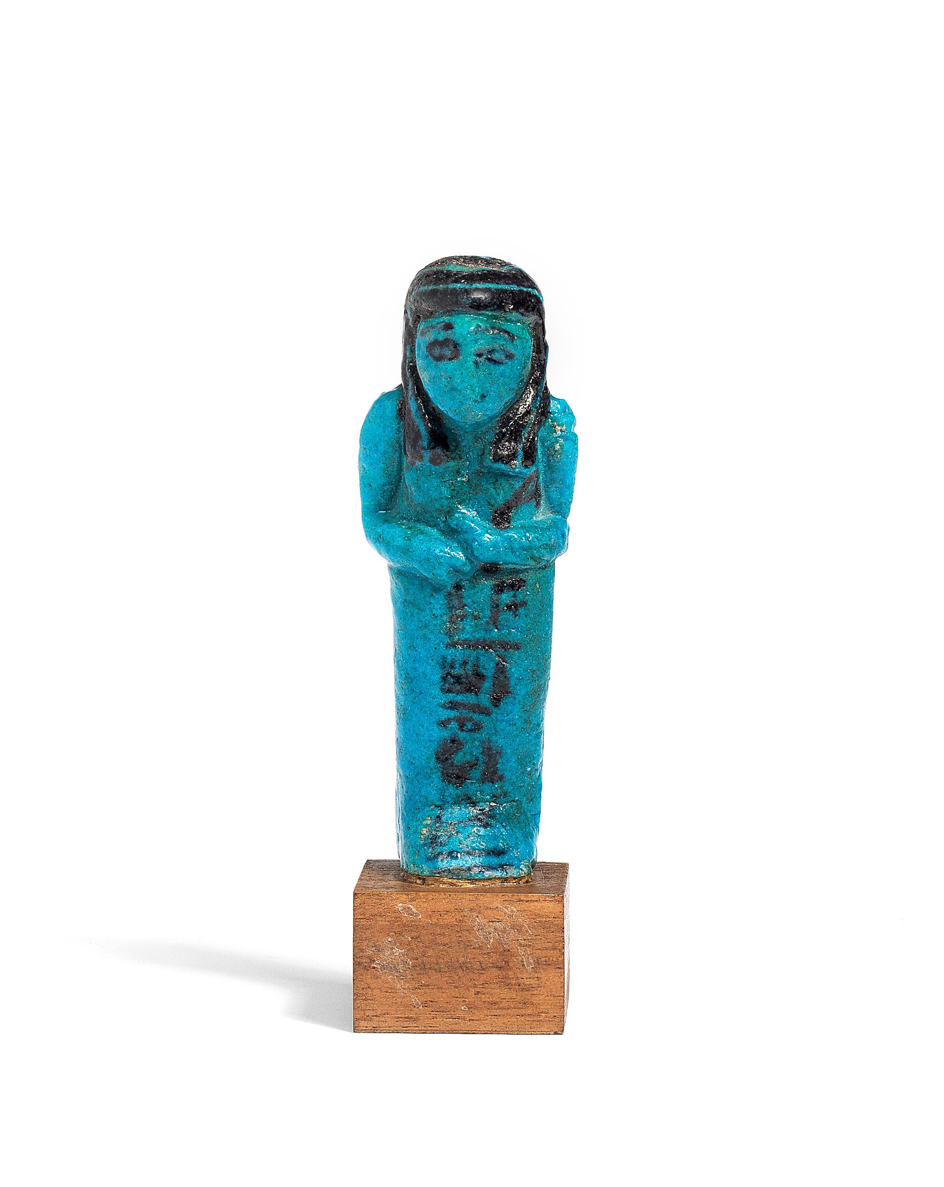 Bonhams : An Egyptian bright blue glazed composition shabti for Wsir-Wer