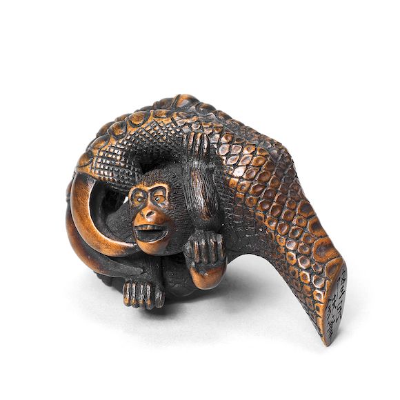 Bonhams : A wood netsuke of a monkey in an eagle's claw By Ryumin, 19th century