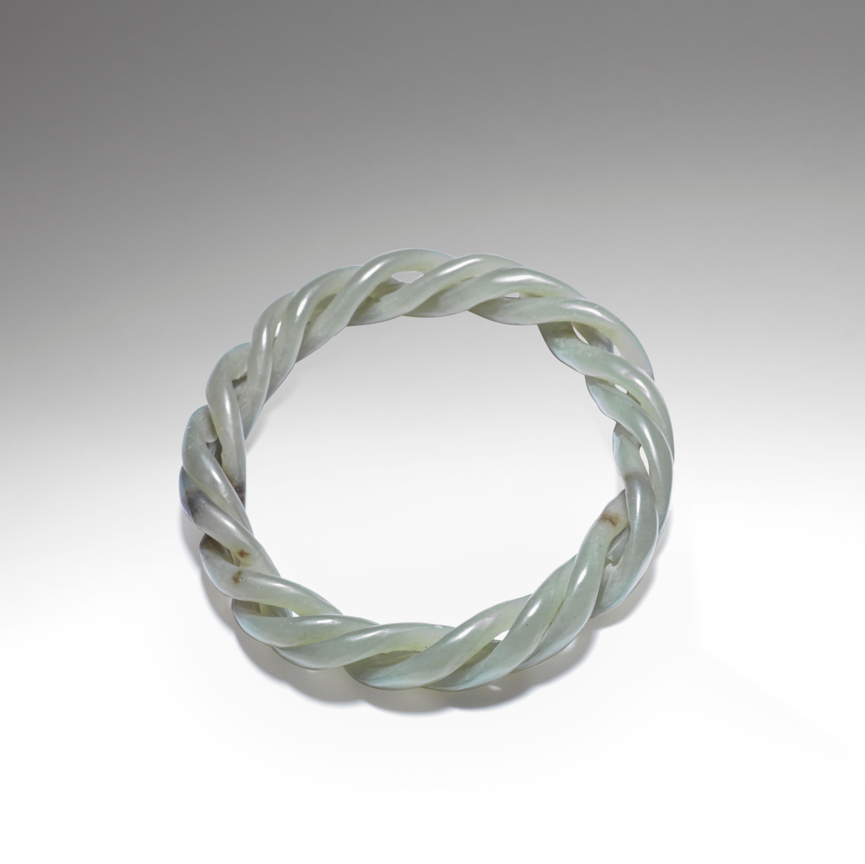 Bonhams : A GREEN AND MUSHROOM JADE ROPE-TWIST BANGLE Qing Dynasty
