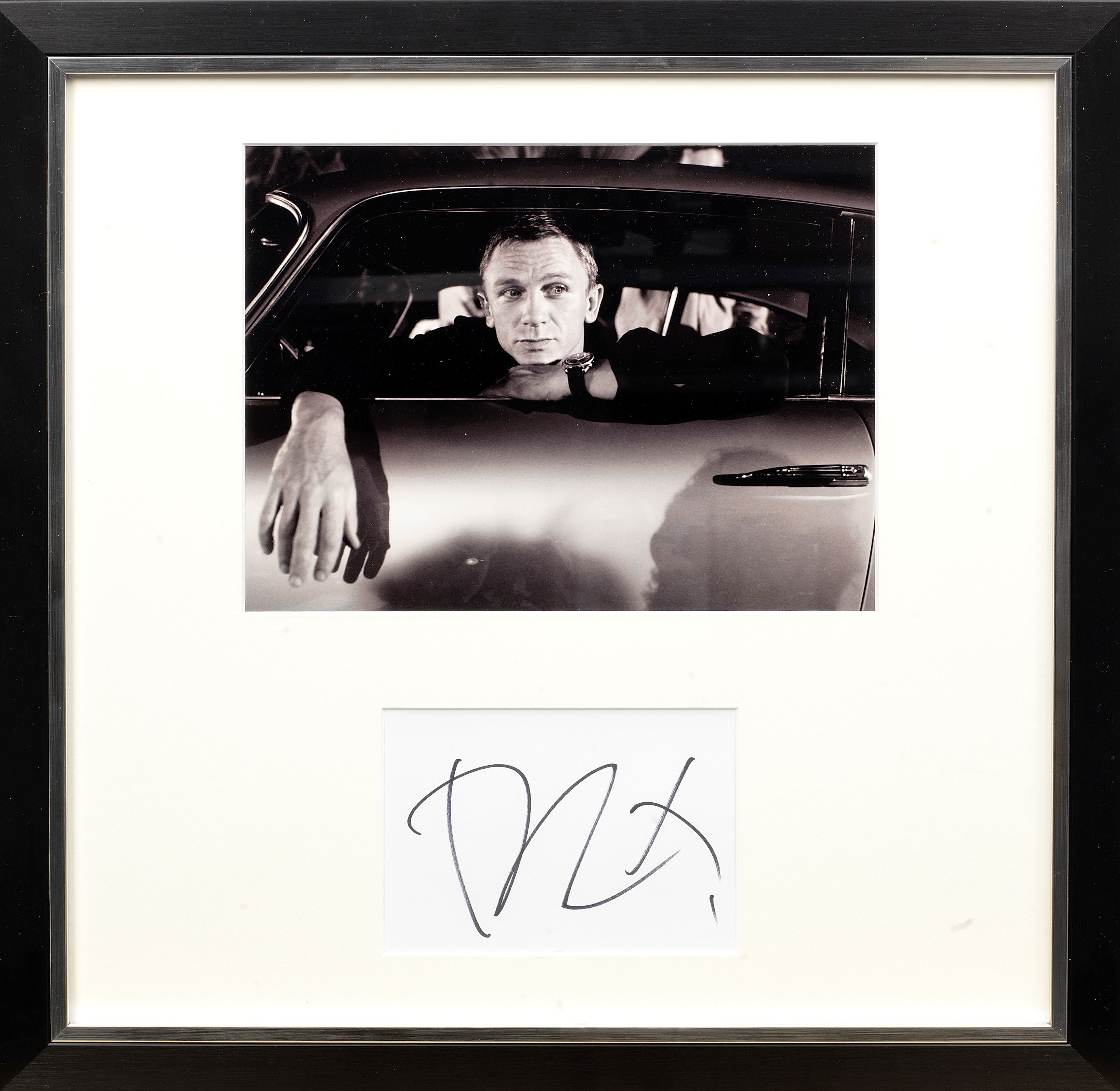 Bonhams Cars : A framed photograph with signature of Daniel Craig with ...