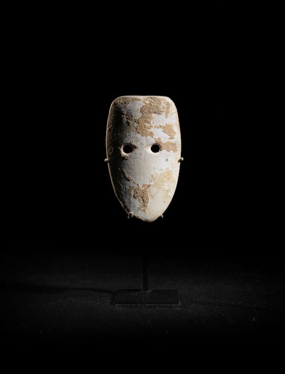 Bonhams : A Neolithic shell spirit mask amulet