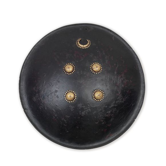 Bonhams : A Mughal lacquered-hide shield (Dhal) with gold-inlaid steel ...