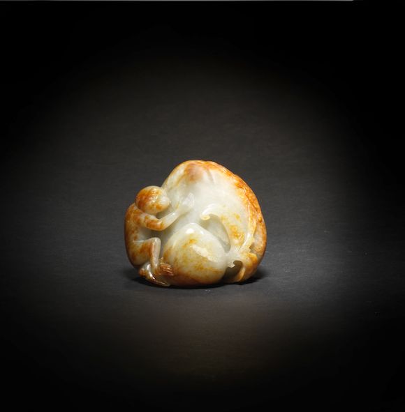 Bonhams : A PALE GREEN AND RUSSET JADE CARVING OF PEACHES AND MONKEY ...