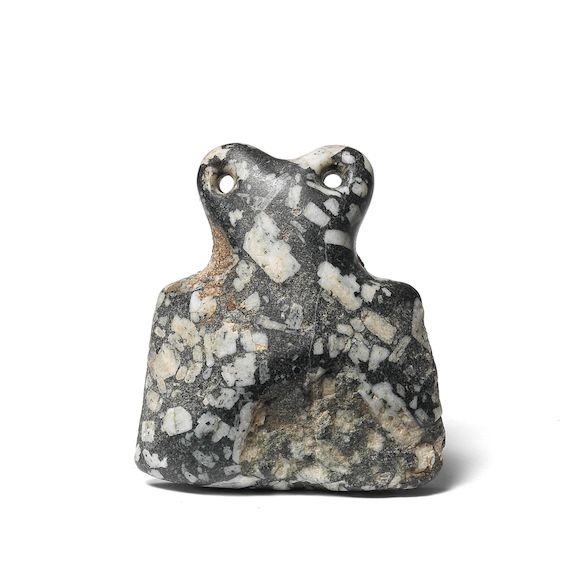 Bonhams : A Western Asiatic mottled stone spectacle idol