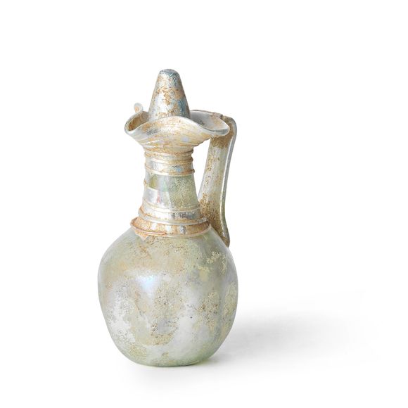 Bonhams : A Roman colourless glass jug with biconical stopper
