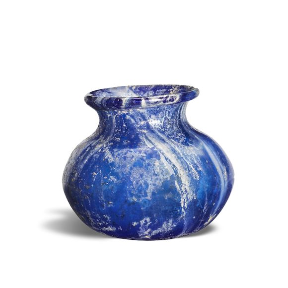 Bonhams : A miniature Roman blue and white marbled glass jar