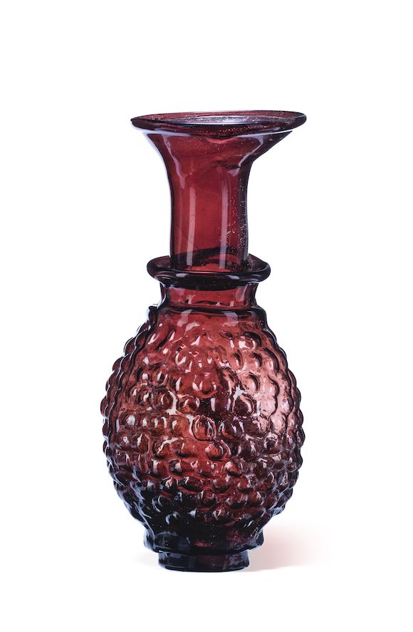 Bonhams : A Roman aubergine glass grape flask
