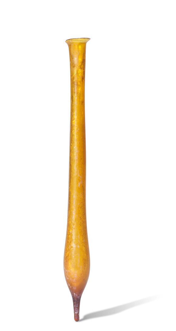 Bonhams : A tall Roman amber glass pointed unguentarium
