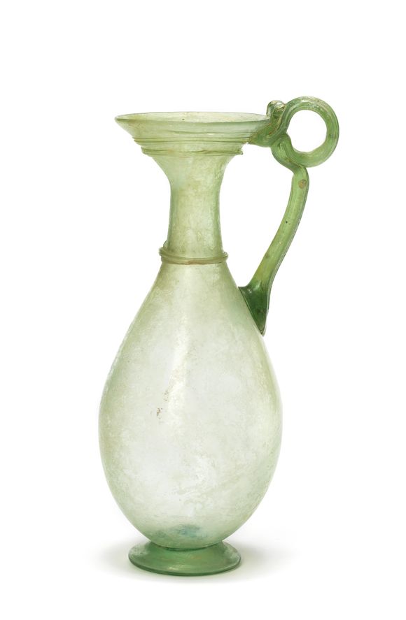 Bonhams : A Roman pale green glass jug with ring handle