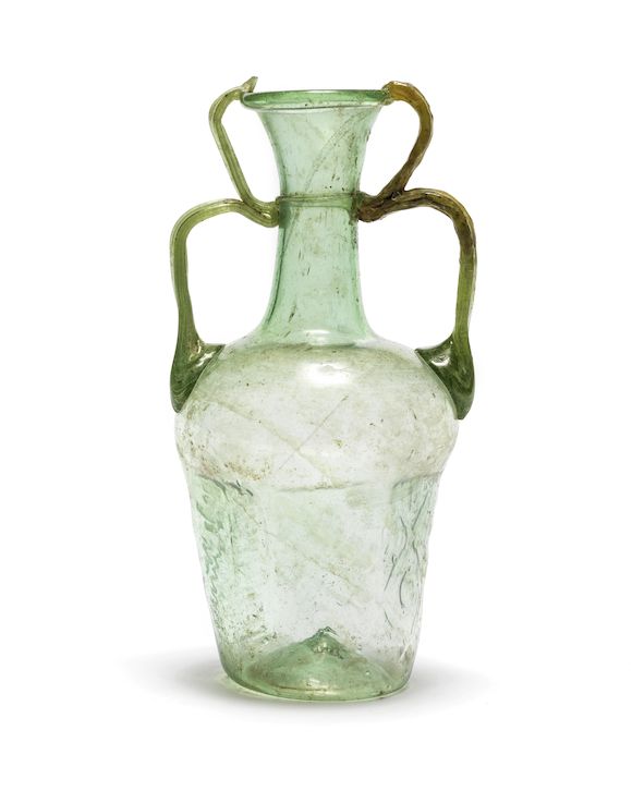 Bonhams : A Roman green glass hexagonal two-handled flask