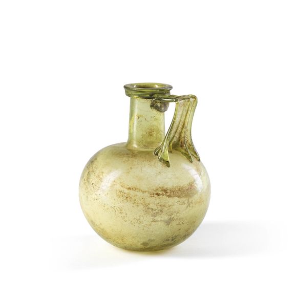 Bonhams : A Roman pale olive green glass spherical jug