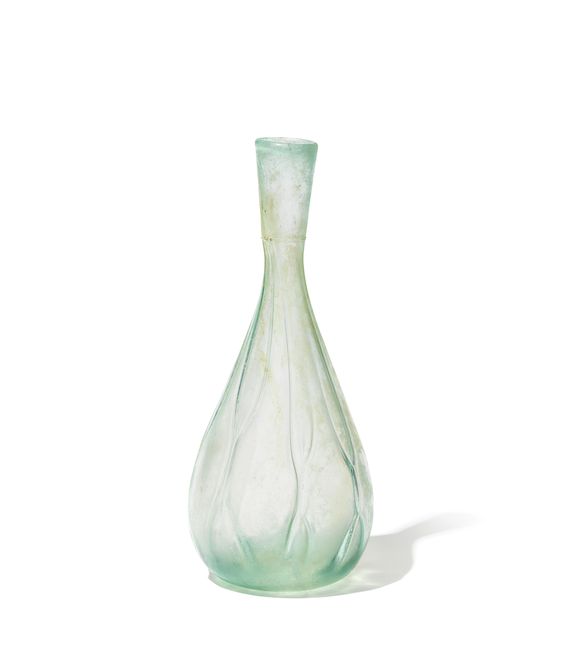 Bonhams : A Roman pale green glass bottle with net-decoration
