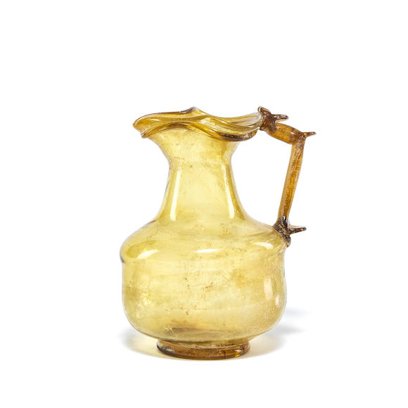Bonhams A Roman Amber Glass Trefoil Lipped Jug