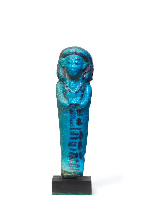 Bonhams : An Egyptian bright blue glazed faience shabti for Amun-em-ipet