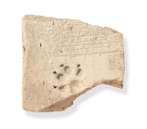 Bonhams : A Neo-Assyrian cuneiform clay brick with paw print