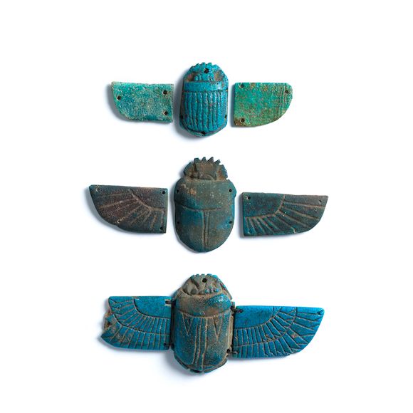 Bonhams : An Egyptian turquoise glazed faience winged scarab, and two ...