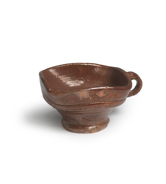 Bonhams : A Dutch lead-glazed earthenware fire pot, circa 1700