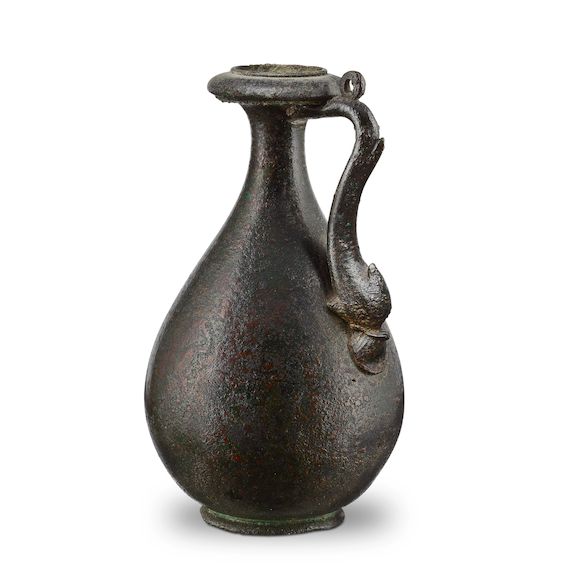 Bonhams : A Roman bronze olpe with dolphin handle