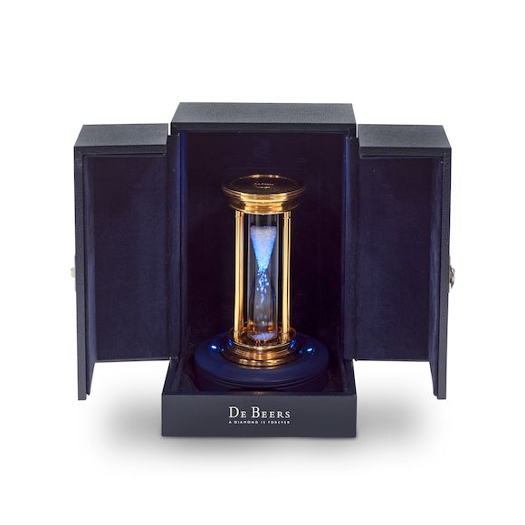 Bonhams : DeBeers. A fine gold plated hourglass with floating diamonds ...