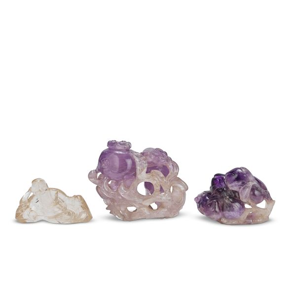Bonhams : TWO CARVED AMETHYST 'FRUIT' CARVINGS AND A ROCK CRYSTAL 'LI ...