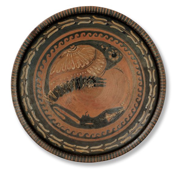 Bonhams : A Greek red-figure plate with a woman's head in profile