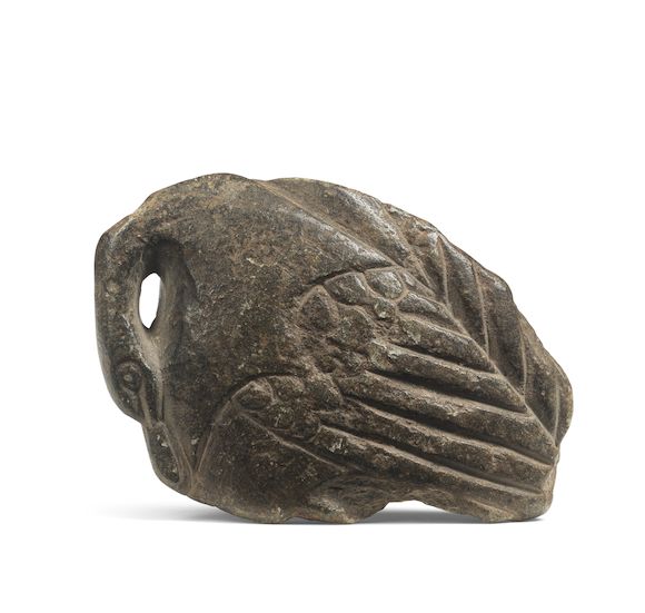 Bonhams : A fragmentary Egyptian steatite cosmetic spoon in the form of ...