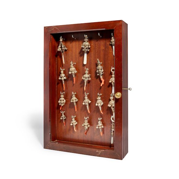 Bonhams : A collection of eighteen baby rattles contained in a display ...