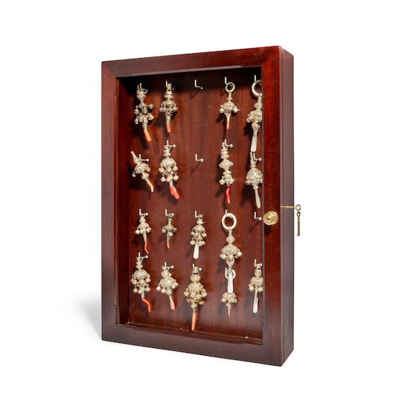 Bonhams : A collection of seventeen baby rattles contained in a display ...