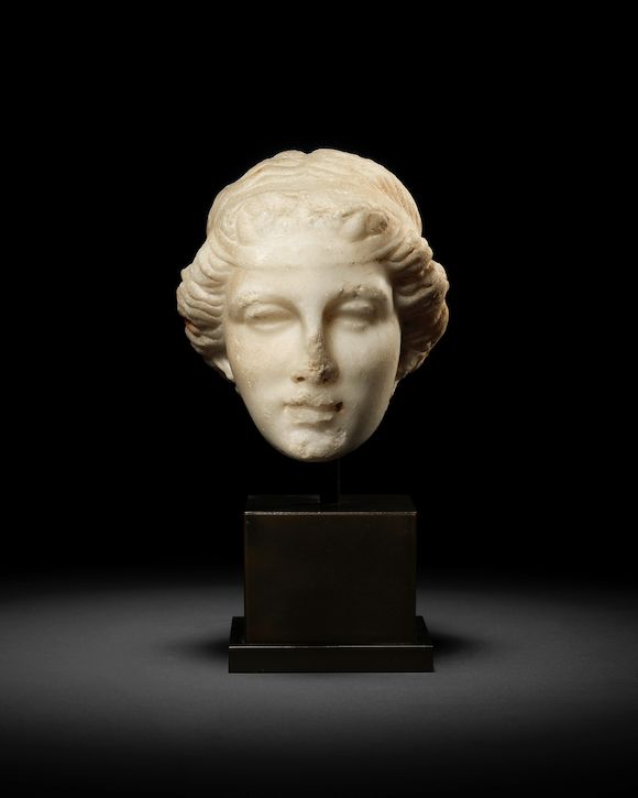 Bonhams : A Greek marble head of a deity wearing a Dionysiac fillet
