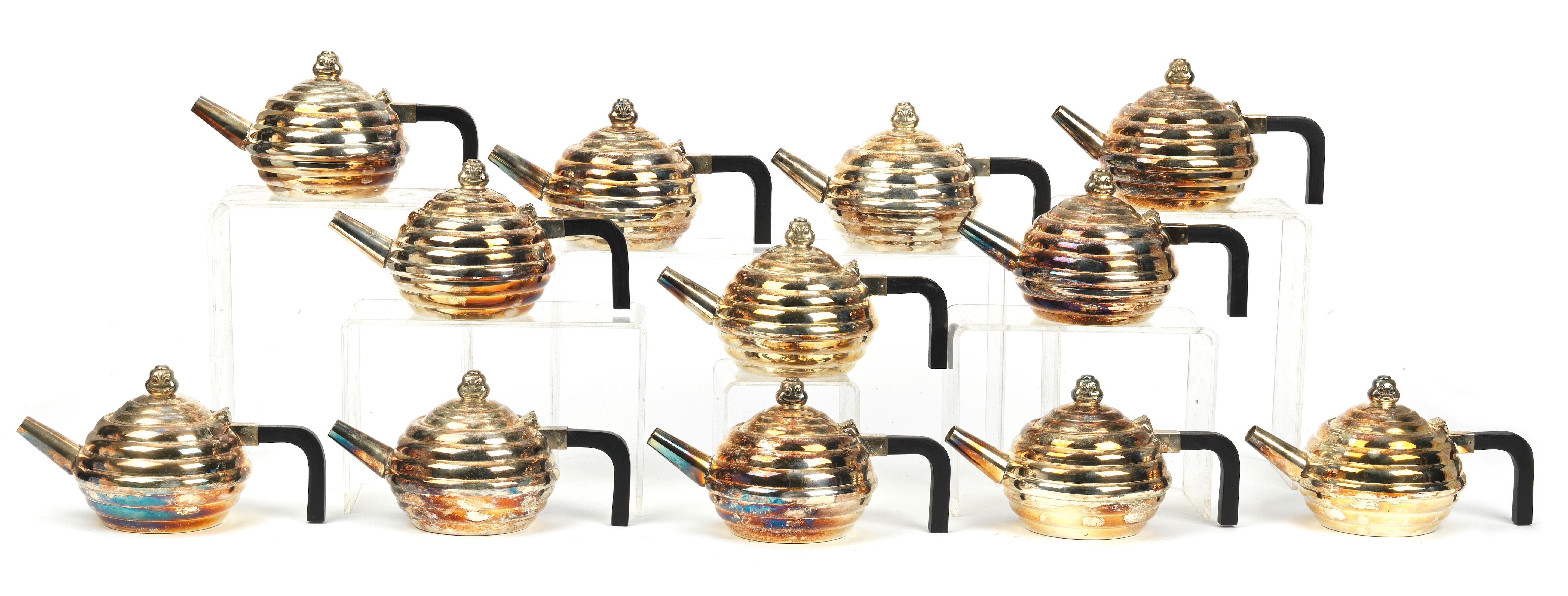 Bonhams Cars : A set of twelve "Mr Bibendum" tea-pots, circa 1930, ((12))