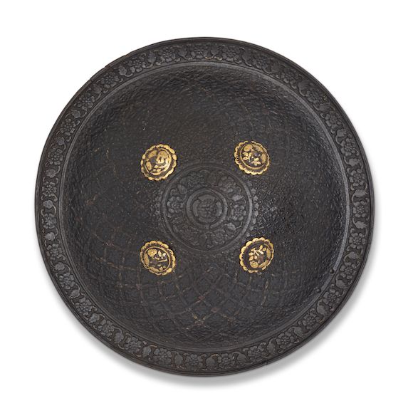 Bonhams : A carved leather shield (dhal) with gold koftgari steel ...