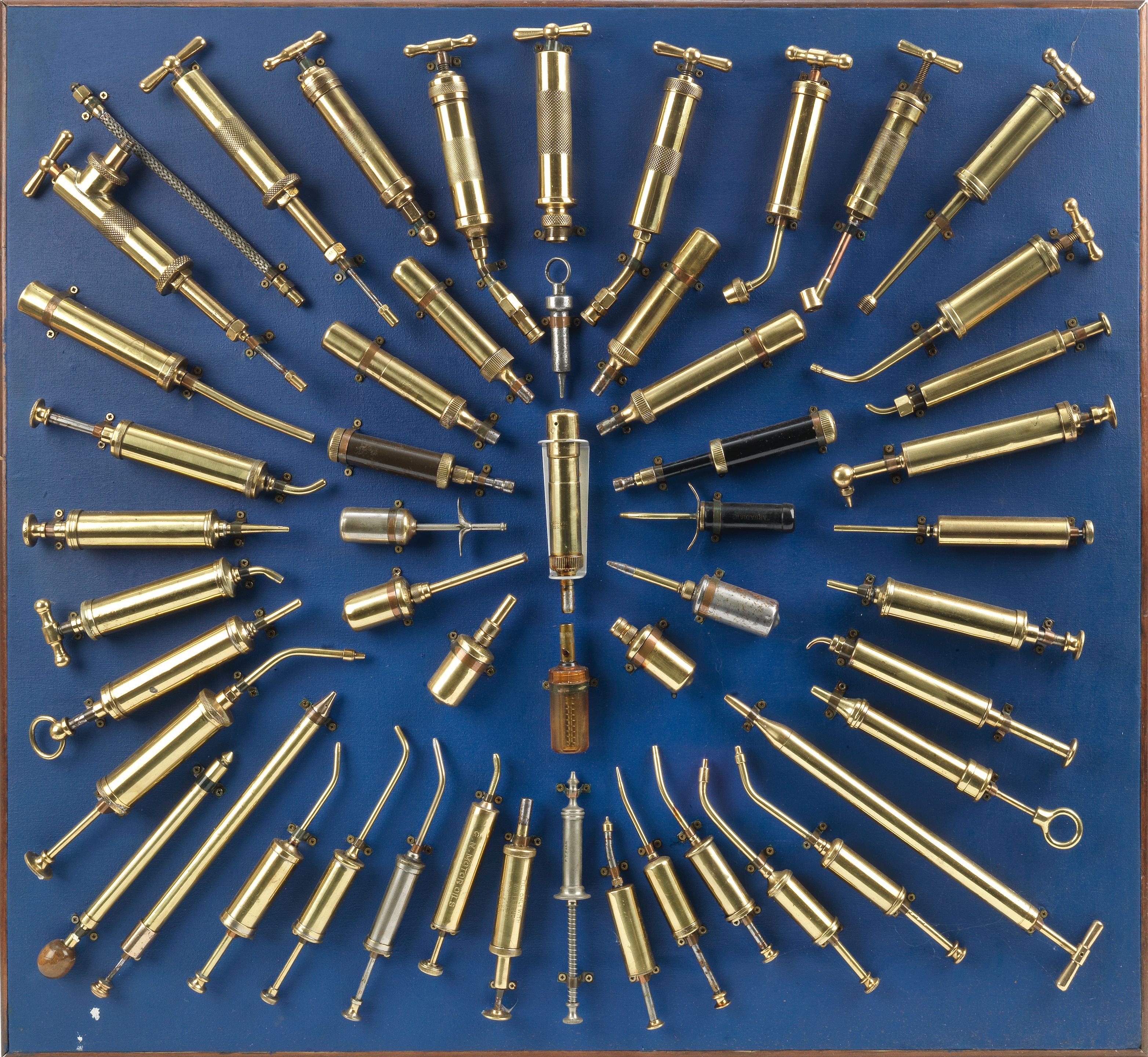 Bonhams Cars : A display board fitted with assorted brass grease guns ...