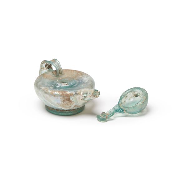 Bonhams : A Roman pale blue glass lamp-filler and pale blue glass ...