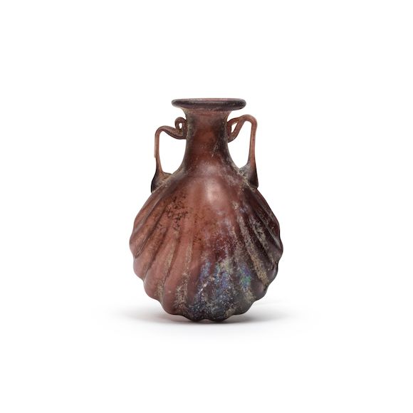 Bonhams : A Roman light purple mould-blown glass shell-shaped amphora
