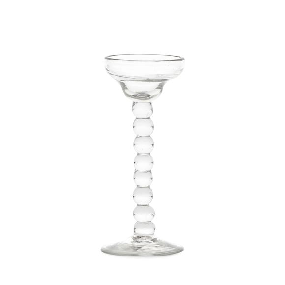 Bonhams : A remarkable bobbin-knopped sweetmeat glass, circa 1720-30